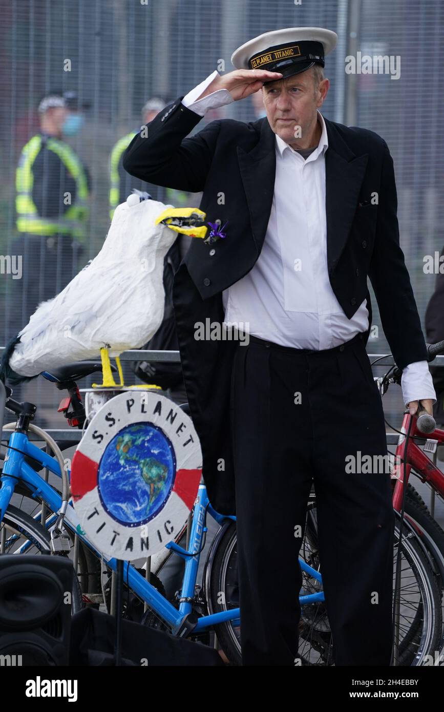A climate activist wearing a sailor costume with a hat that says "SS ...