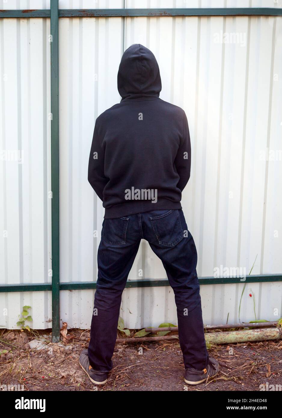 Rear View of Person Pee on the Wall Stock Photo - Alamy