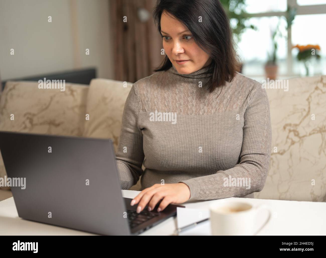 Home Office Concept. woman working on laptop remotely on background of ...