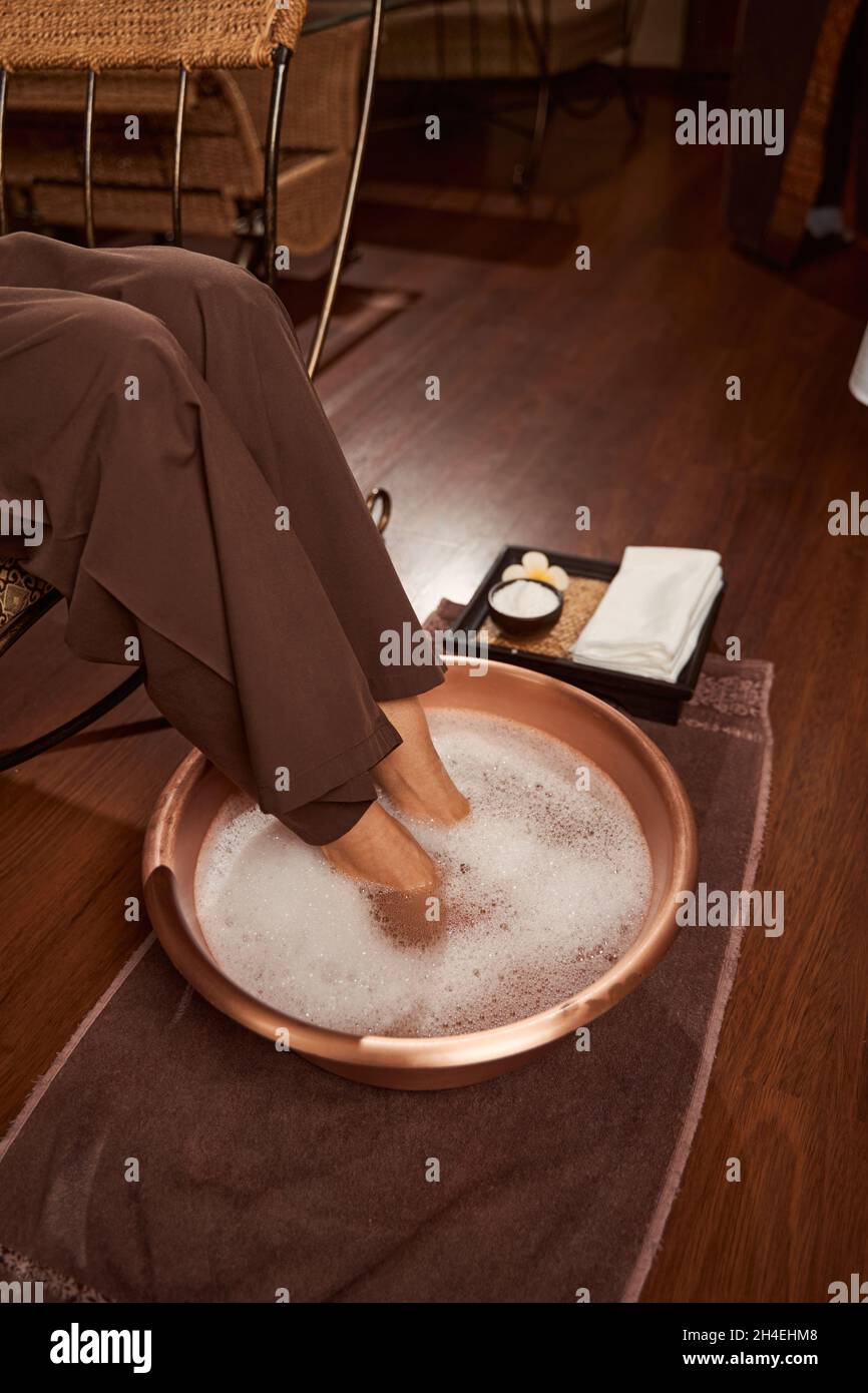 Client having foot bath in wellness center Stock Photo - Alamy
