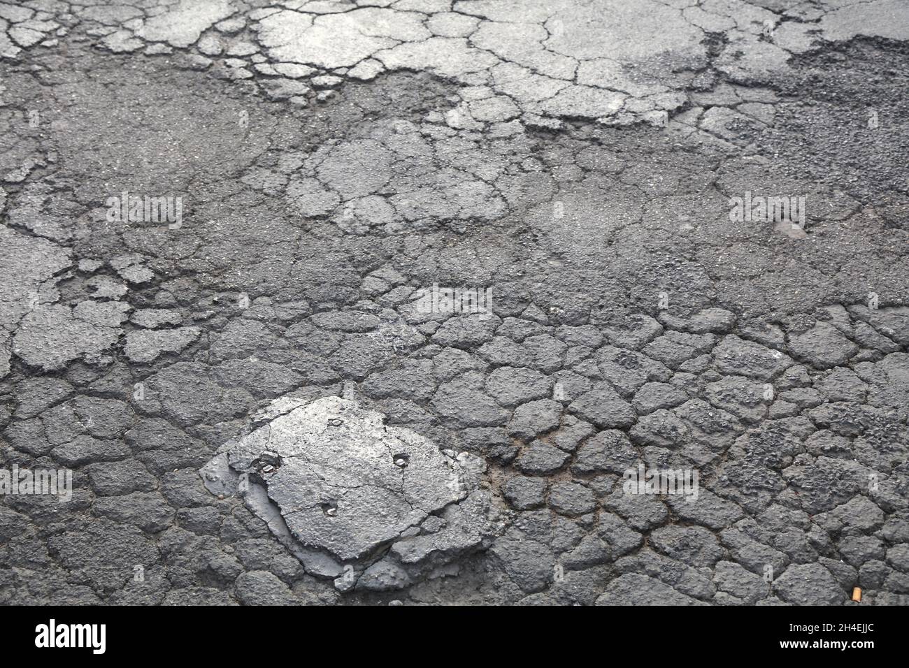 Damaged road. Bad road surface quality with multiple potholes and ...