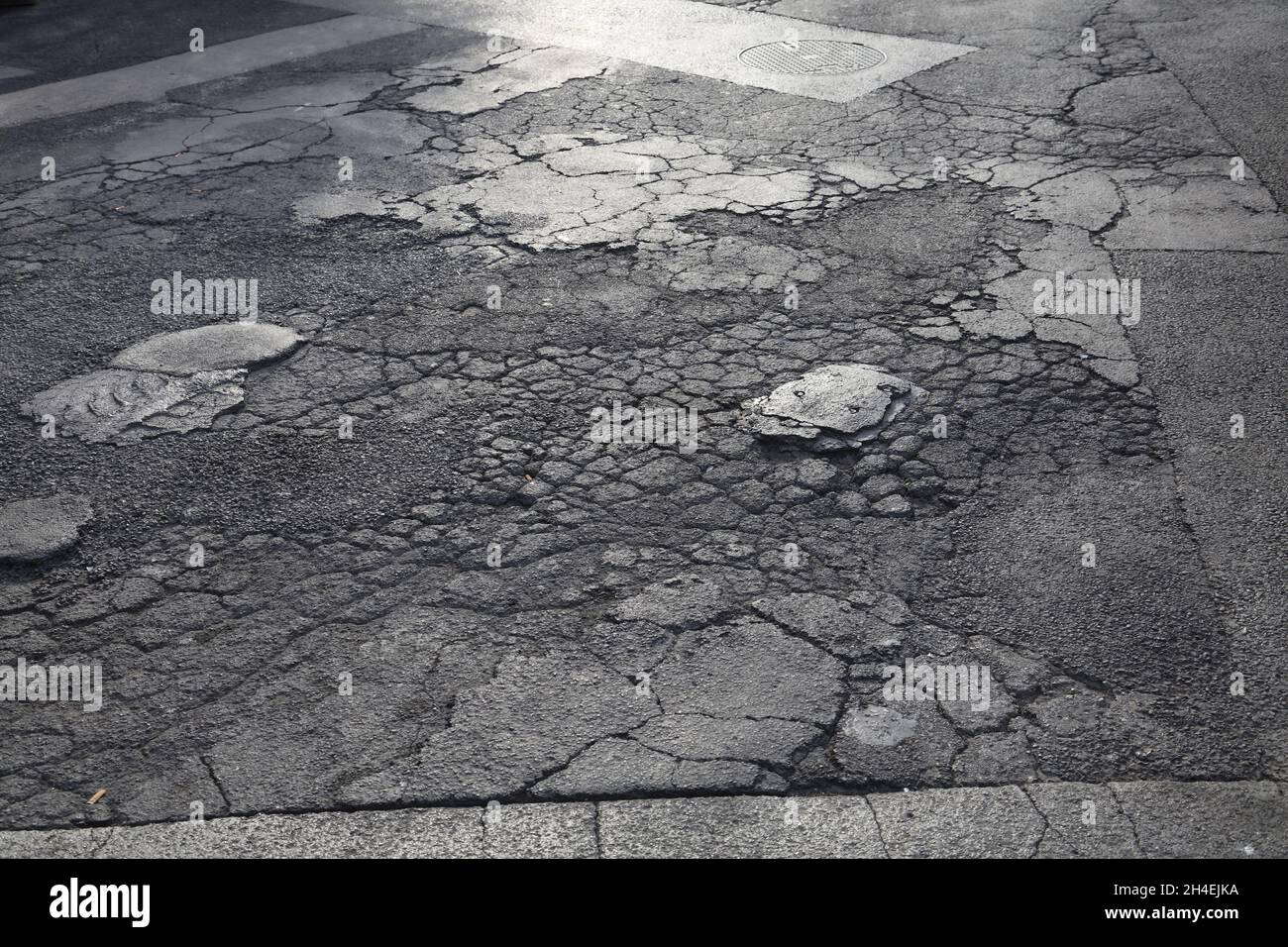 Damaged road surface. Bad road quality with multiple potholes and ...