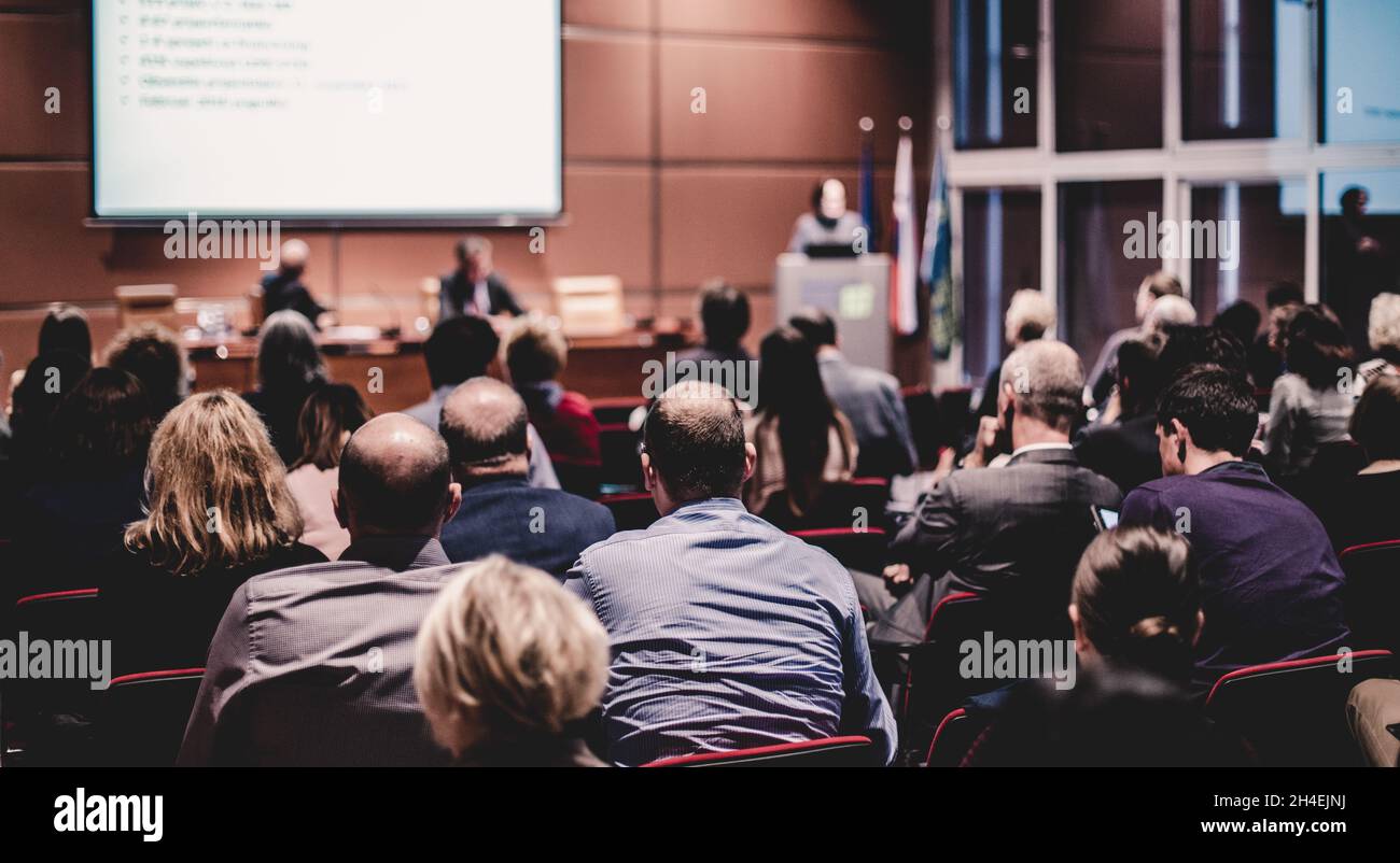 Audience in lecture hall participating at business event Stock Photo ...