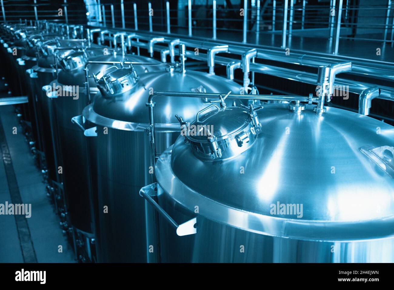 Private microbrewery. Modern beer plant with brewering kettles, tubes ...