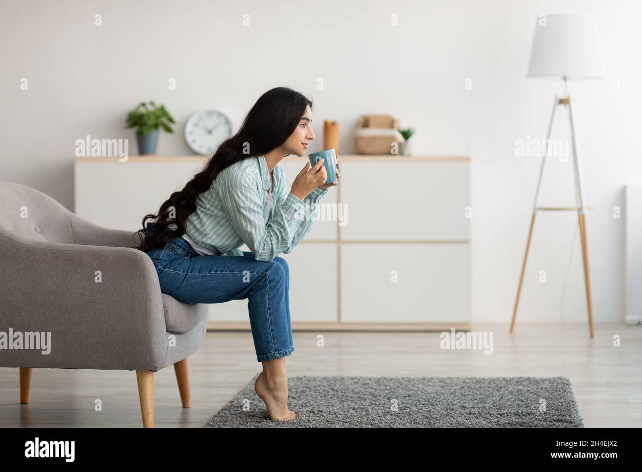 Lazy woman sitting in armchair hi-res stock photography and images - Alamy