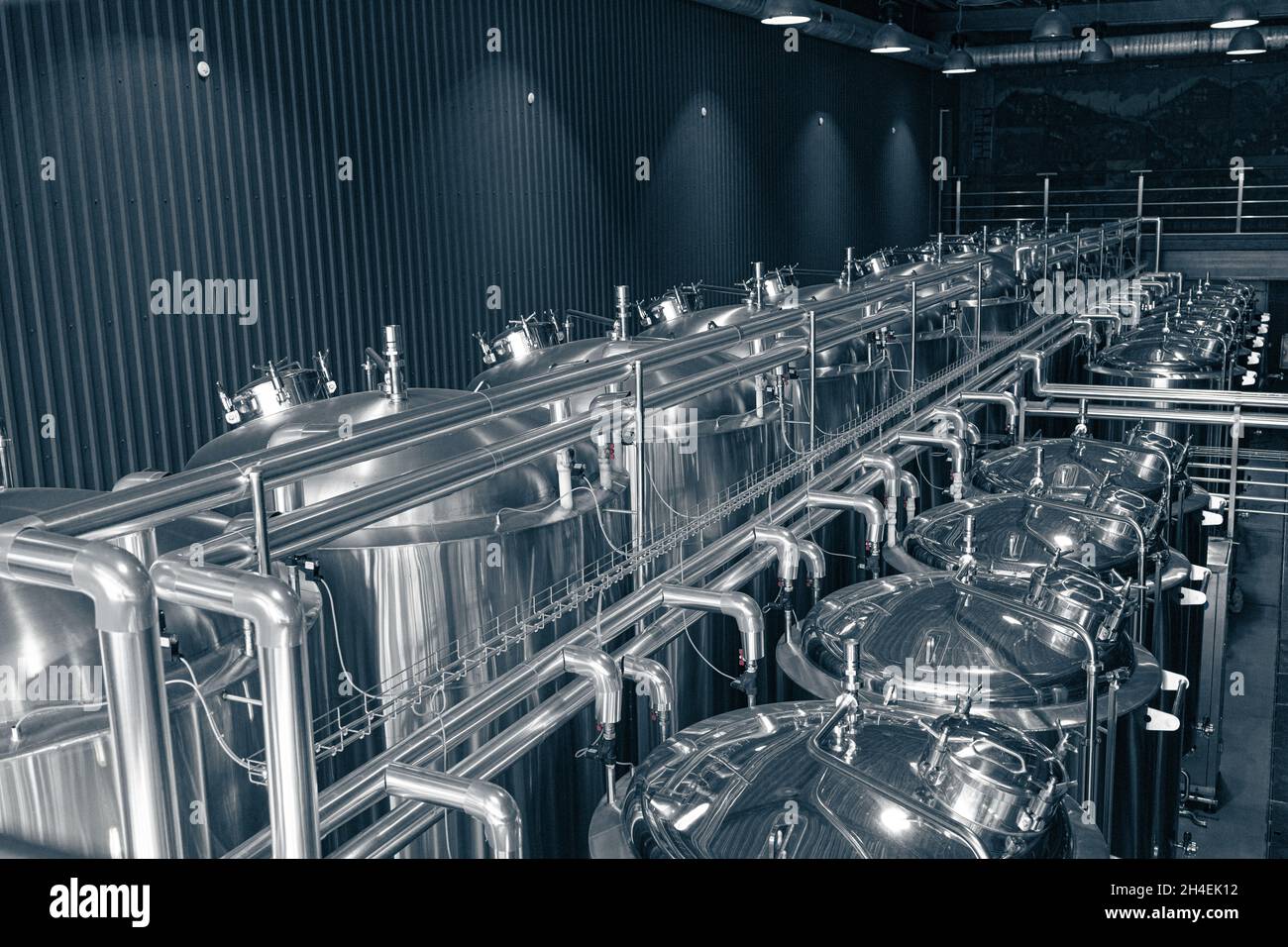 Private microbrewery. Modern beer plant with brewering kettles, tubes ...