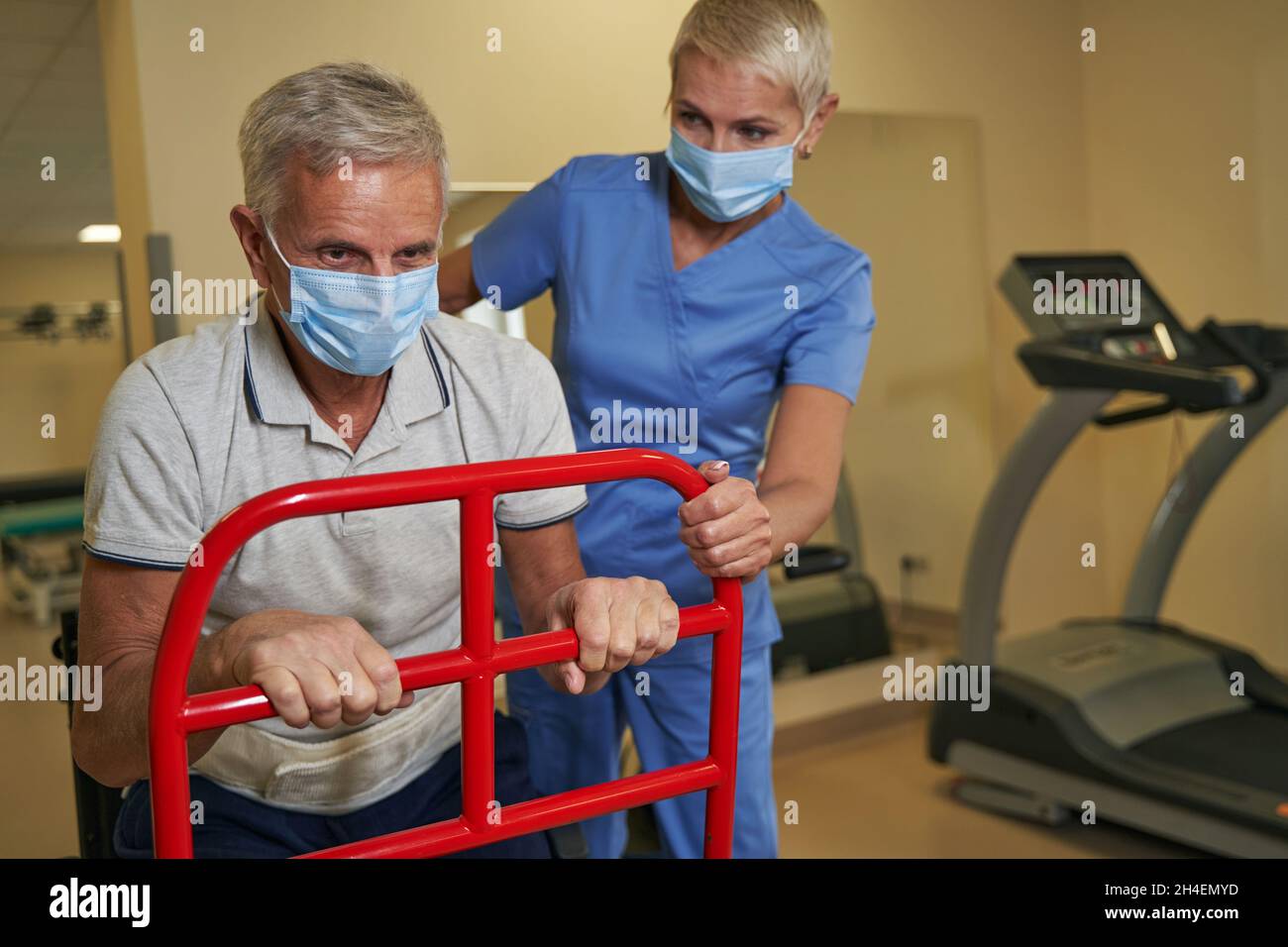 Photo of stroke person using walking frame in medical clinic Stock ...