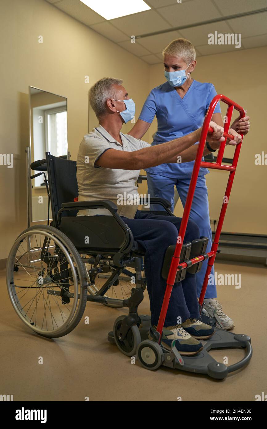 Shot of person with physical disability treated in clinic Stock Photo ...