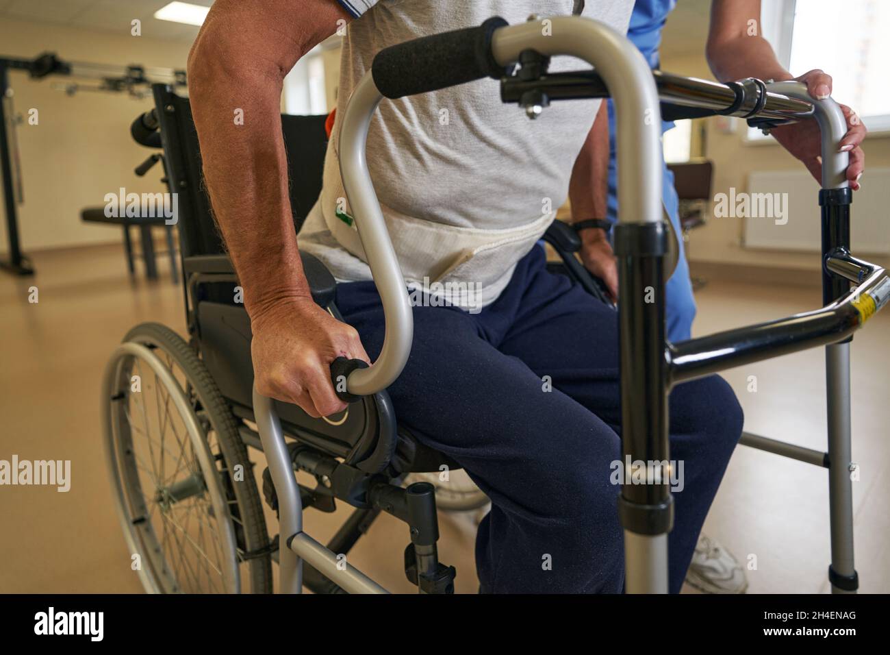 Stroke patient standing up with walking frame in hospital Stock Photo ...