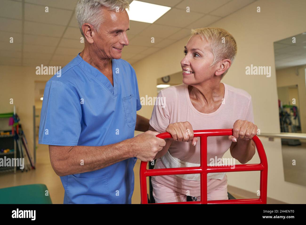 Stroke patient using walking frame in medical clinic Stock Photo - Alamy