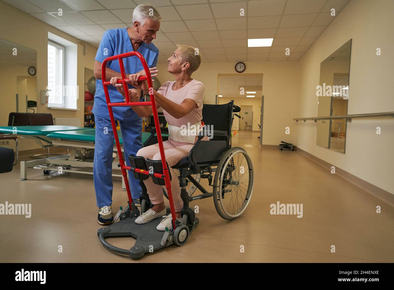 Woman with physical disability uses walking frame indoors Stock Photo ...