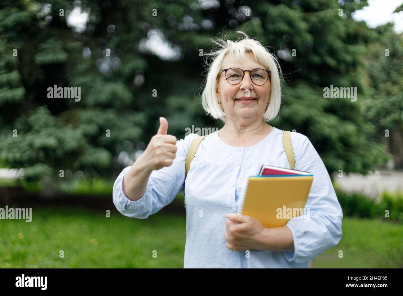 Smiling blonde teacher woman lady 40s 50s years old wearing eyeglasses ...