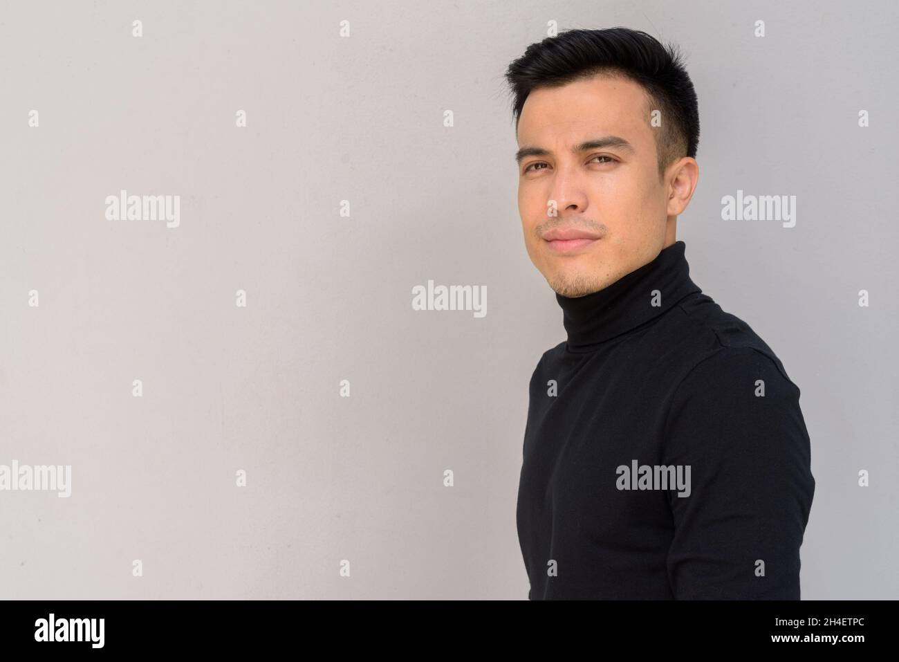 Portrait of handsome young man against gray background horizontal shot ...
