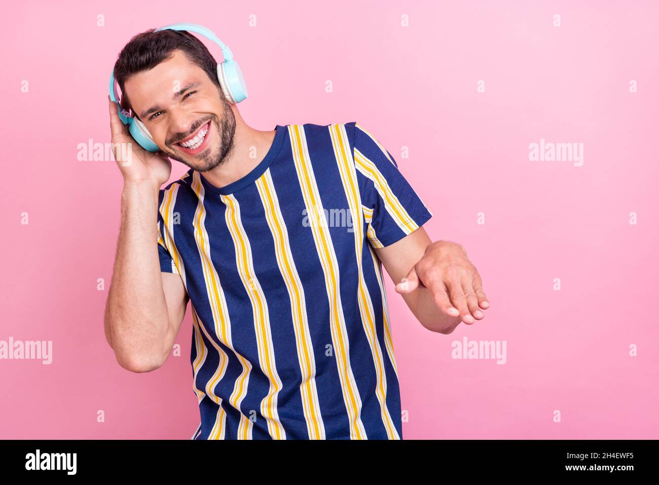 Portrait of attractive cheerful guy listening hit melody stereo having ...