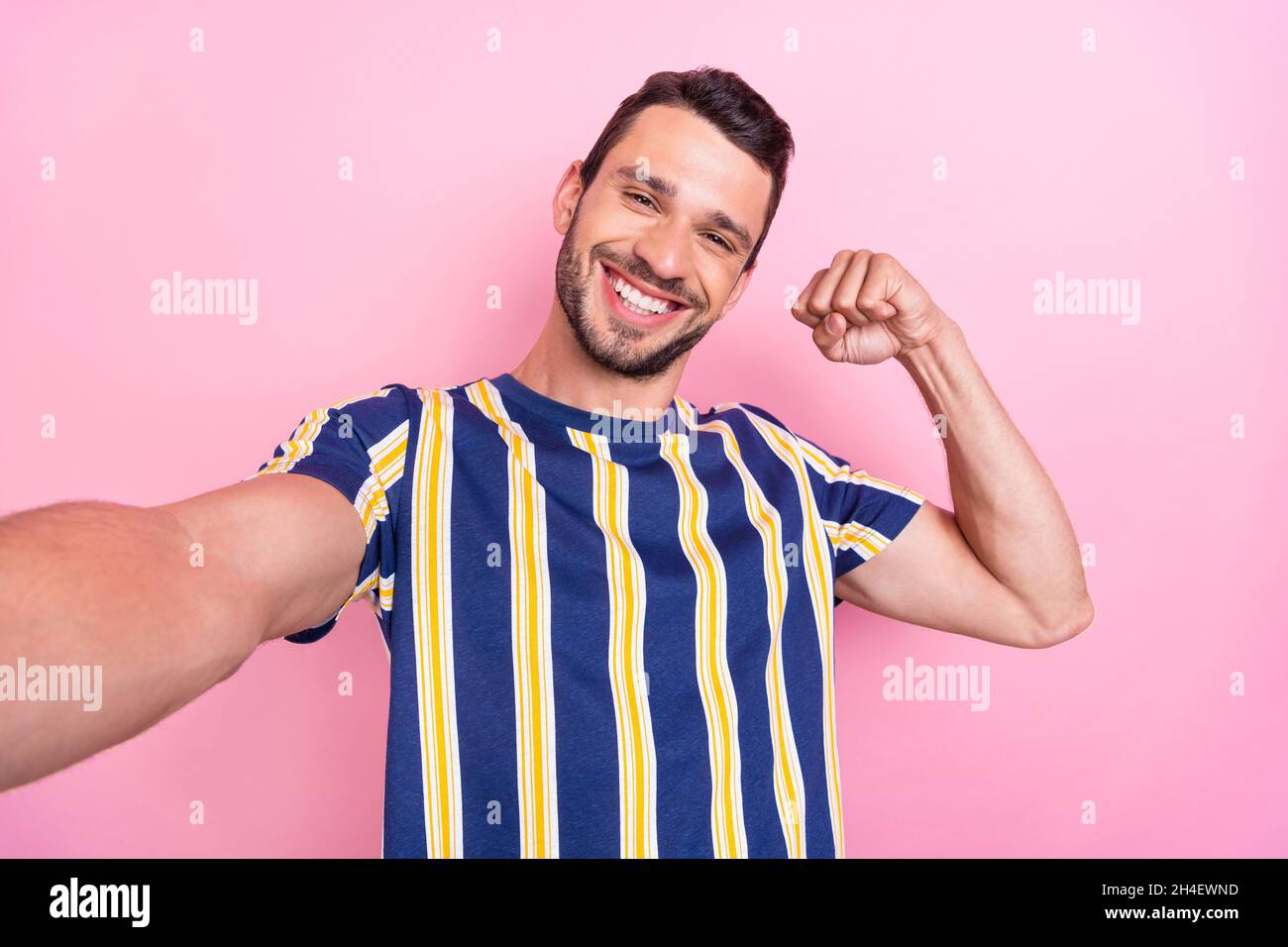 Self-portrait of attractive successful cheerful guy showing muscles ...