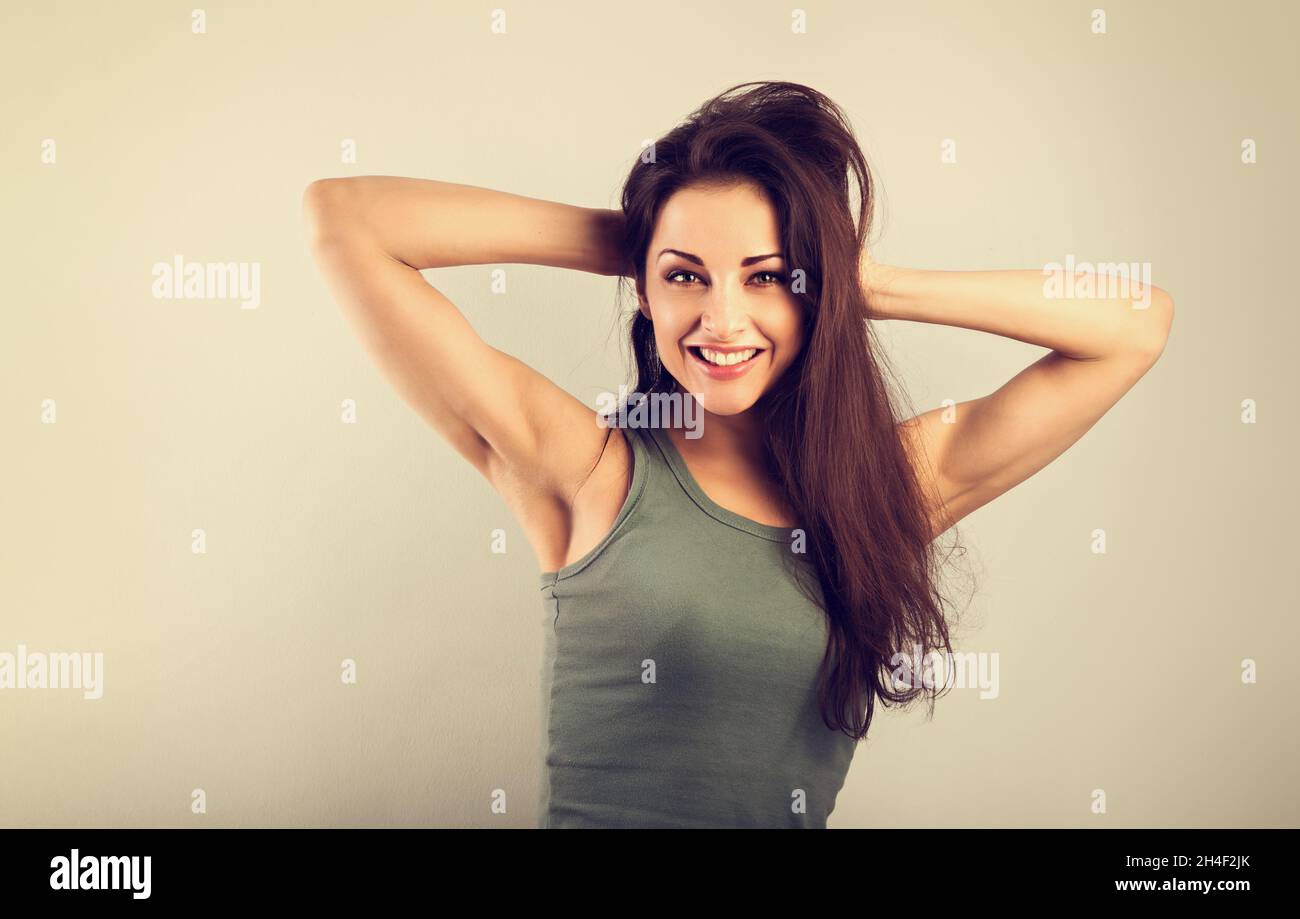 Happy laughing beautiful woman with epilation armpits holding muscular ...