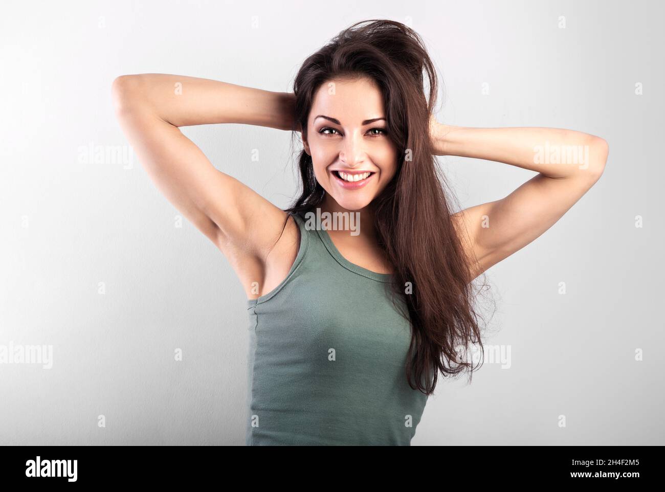 Happy laughing beautiful woman with epilation armpits holding muscular ...