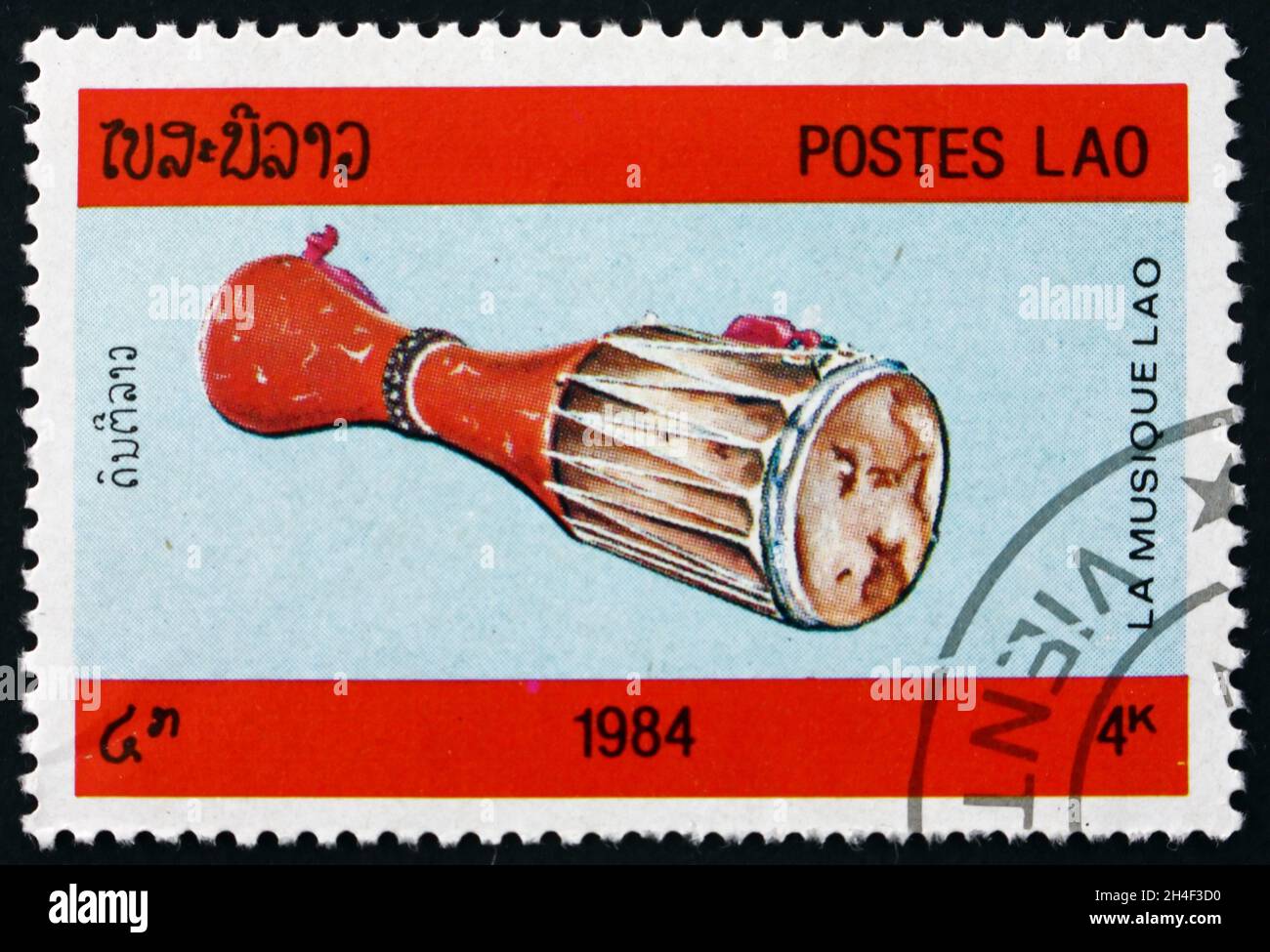LAOS - CIRCA 1984: a stamp printed in Laos shows hand drum, musical ...