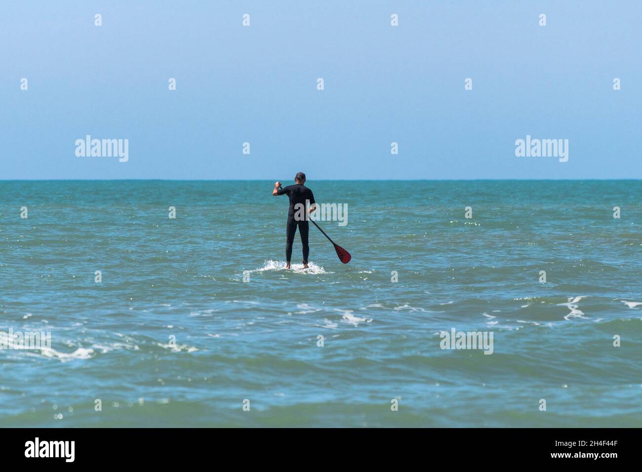 Man practicing Stand up paddle in the sea Stock Photo - Alamy
