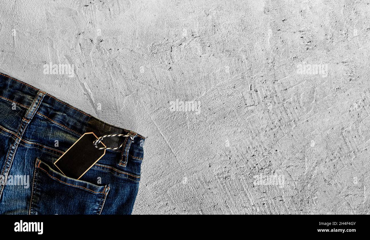 Overhead photo of a pair of jeans with empty tag. Clothing and apparel ...