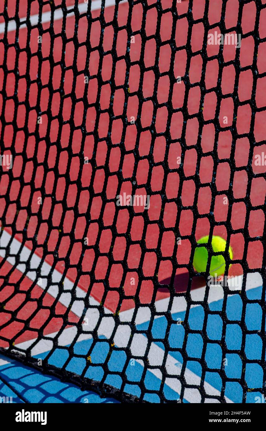 two balls on a red and blue tennis court Stock Photo - Alamy