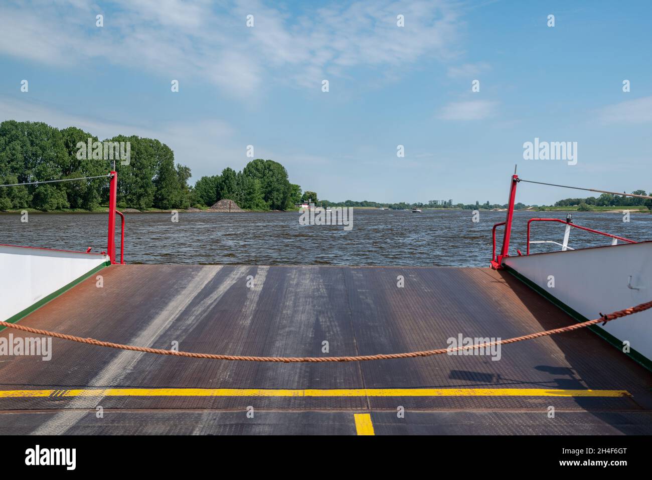 View of the ramp of a ferry and a river with trees on the bank Stock ...