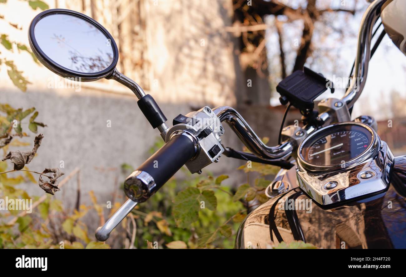 handlebar and speedometer of classic chopper motorcycle in autumn ...
