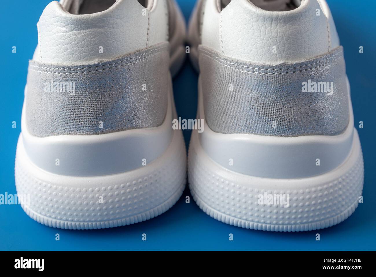 the back of leather sneaker on a blue background Stock Photo - Alamy