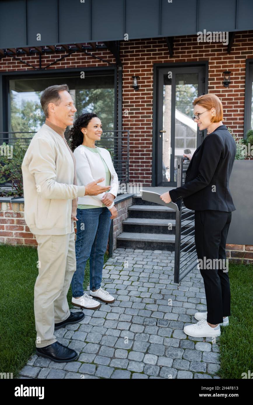 Smiling man looking at house exterior hi-res stock photography and ...