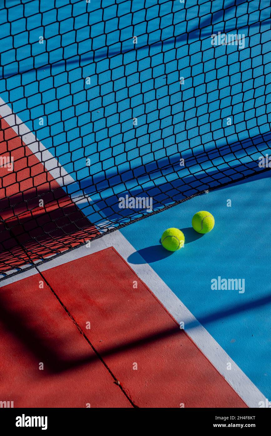 two balls on a red tennis court Stock Photo - Alamy