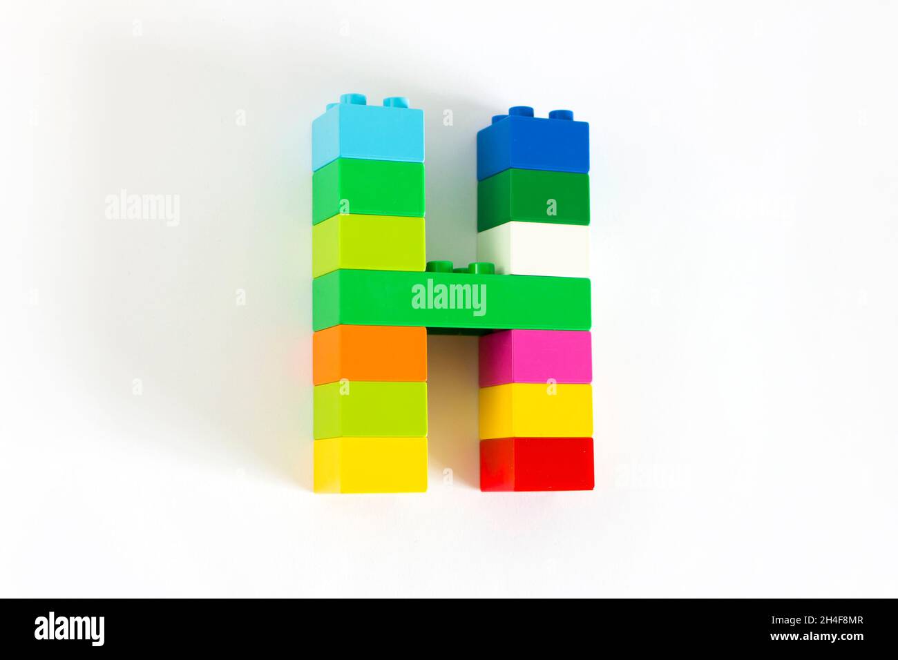 Colorful toy brick letter H isolated on the white background Stock ...
