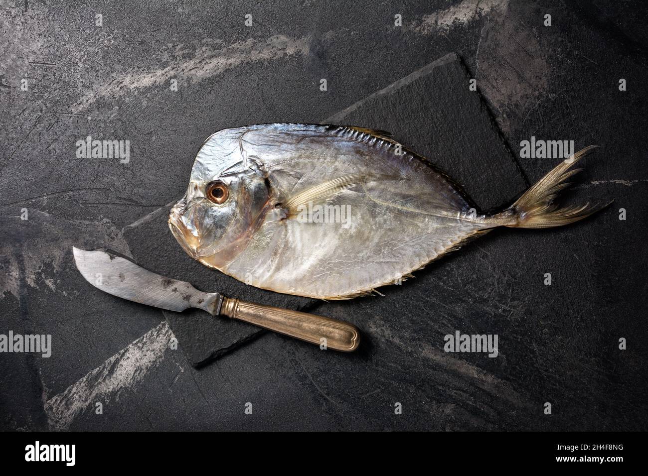 Top view of tasty salty dried sea fish vomer or Selena with silver ...