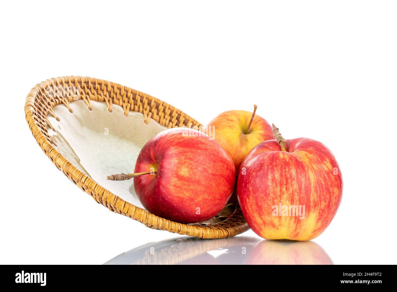 Three juicy red apples with a ceramic dish, close-up isolated on white ...