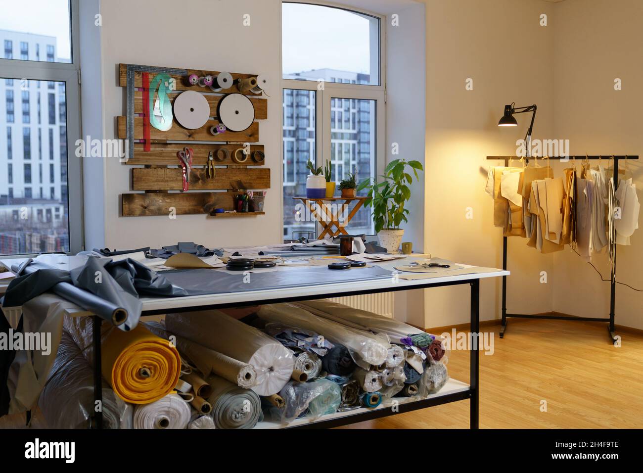 Fashion designer studio with table, fabric and paper patterns for ...