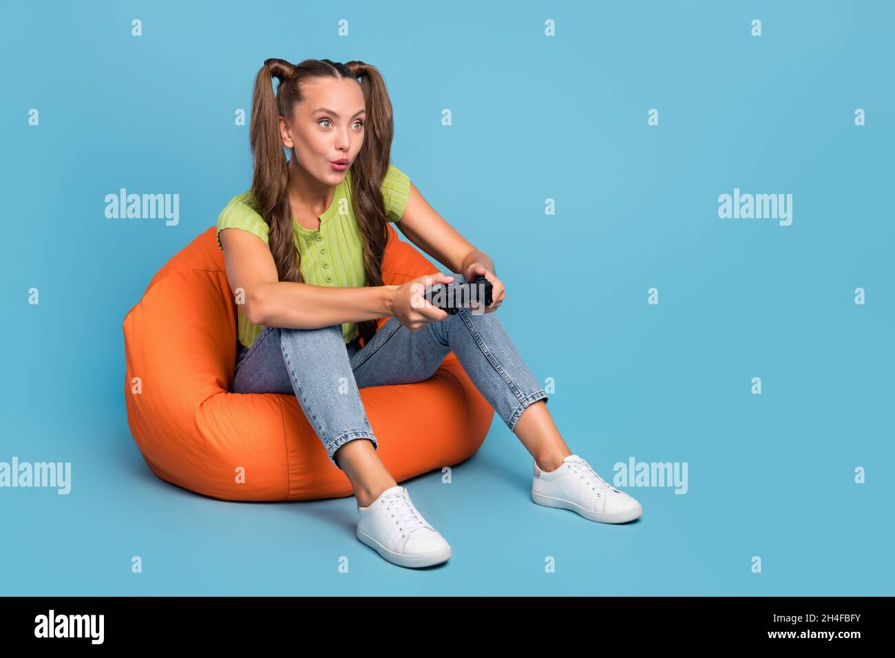 Full length photo of funky young brunette lady sit on chair play ...