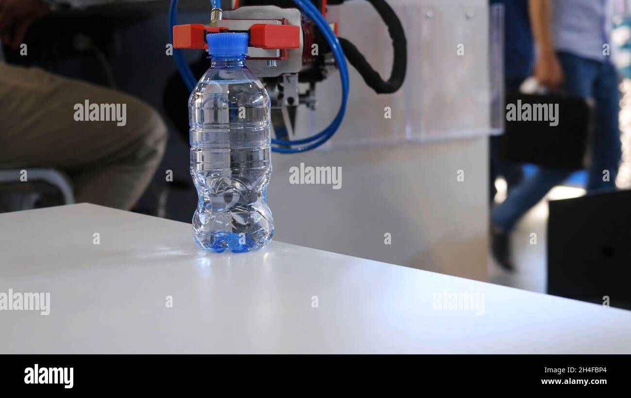 Robot hand is holding a bottle of water. Media. Technological progress ...