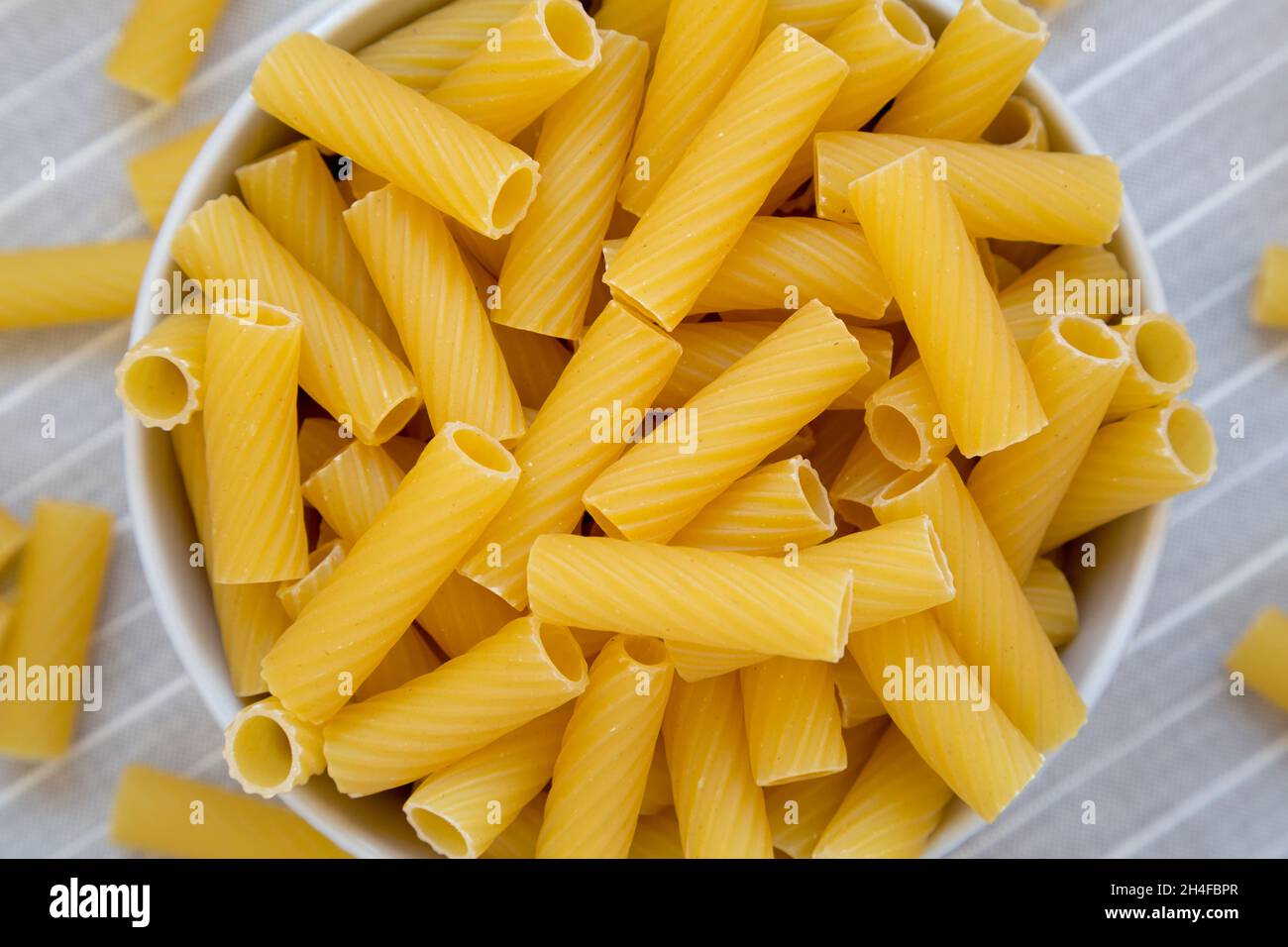 Dry Rigatoni Pasta in a gray Bowl, top view. Flat lay, overhead, from ...