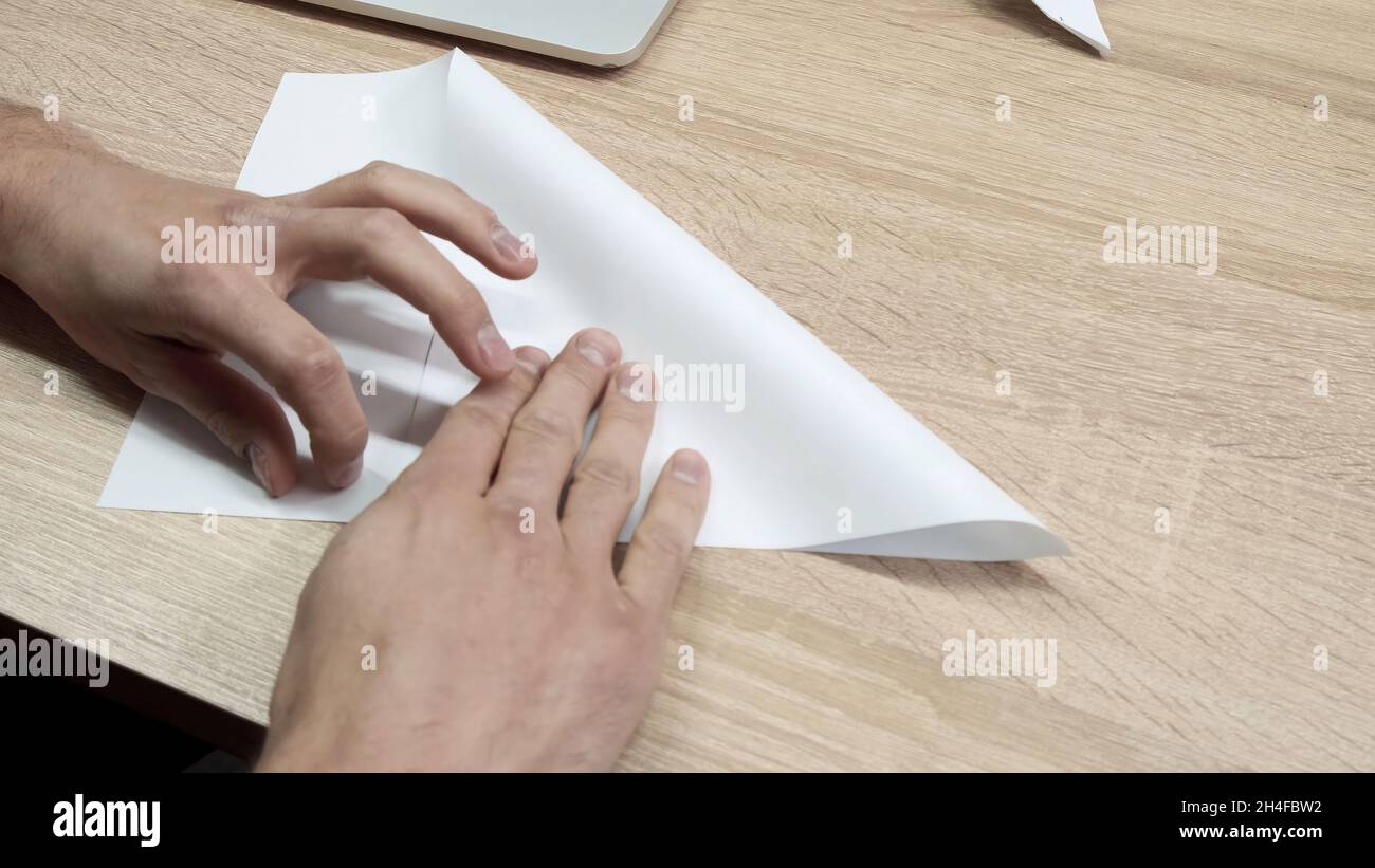 Hands folding paper airplane hi-res stock photography and images - Alamy