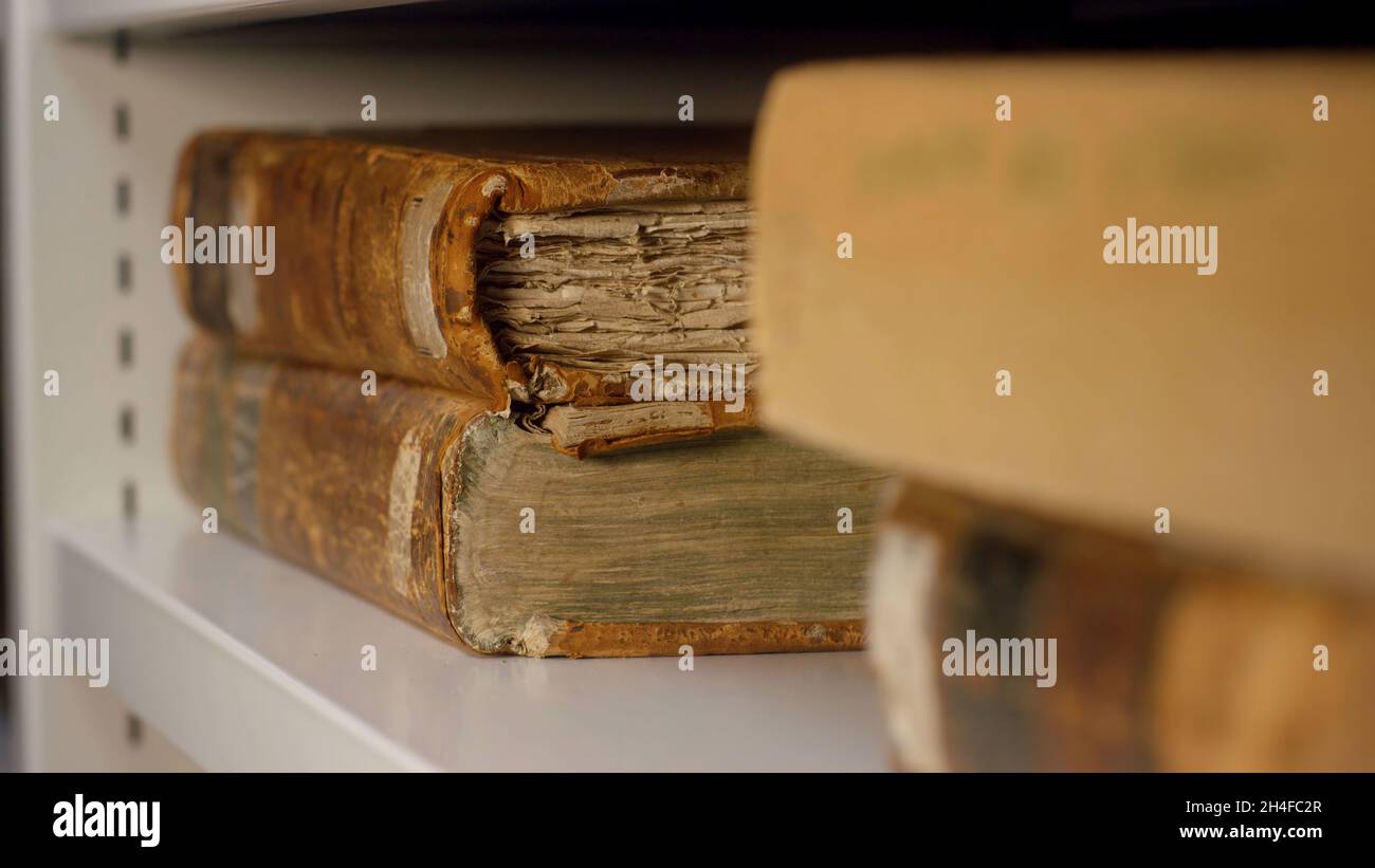Expert takes an old book from the shelf. Stock footage. An ancient ...