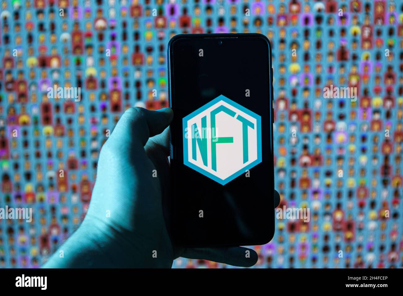 NTF logo on smartphone in NTF's background. A non-fungible token is a ...