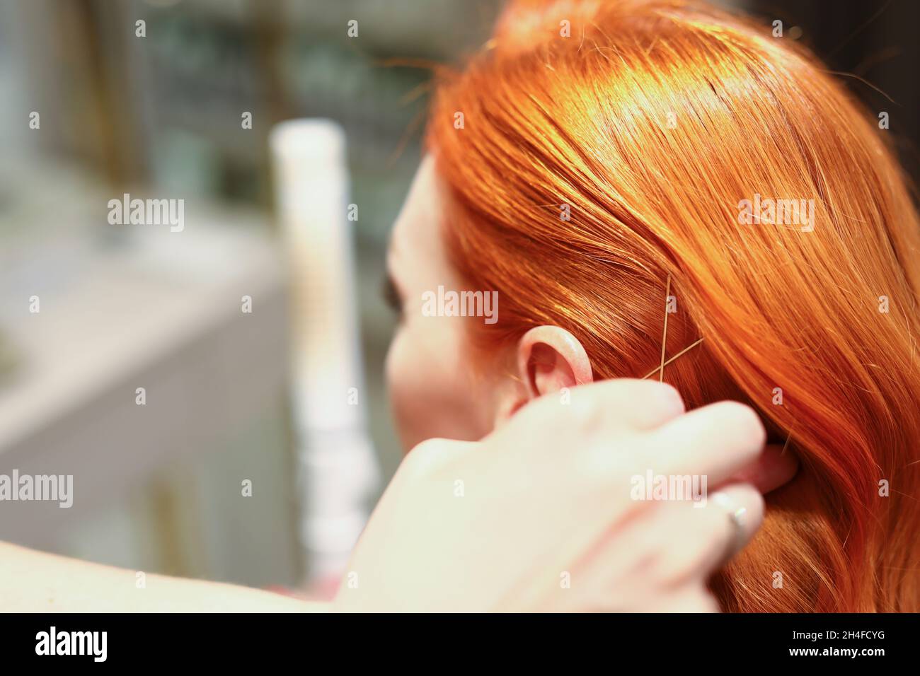 Persons hand correct strand of hair Stock Photo - Alamy