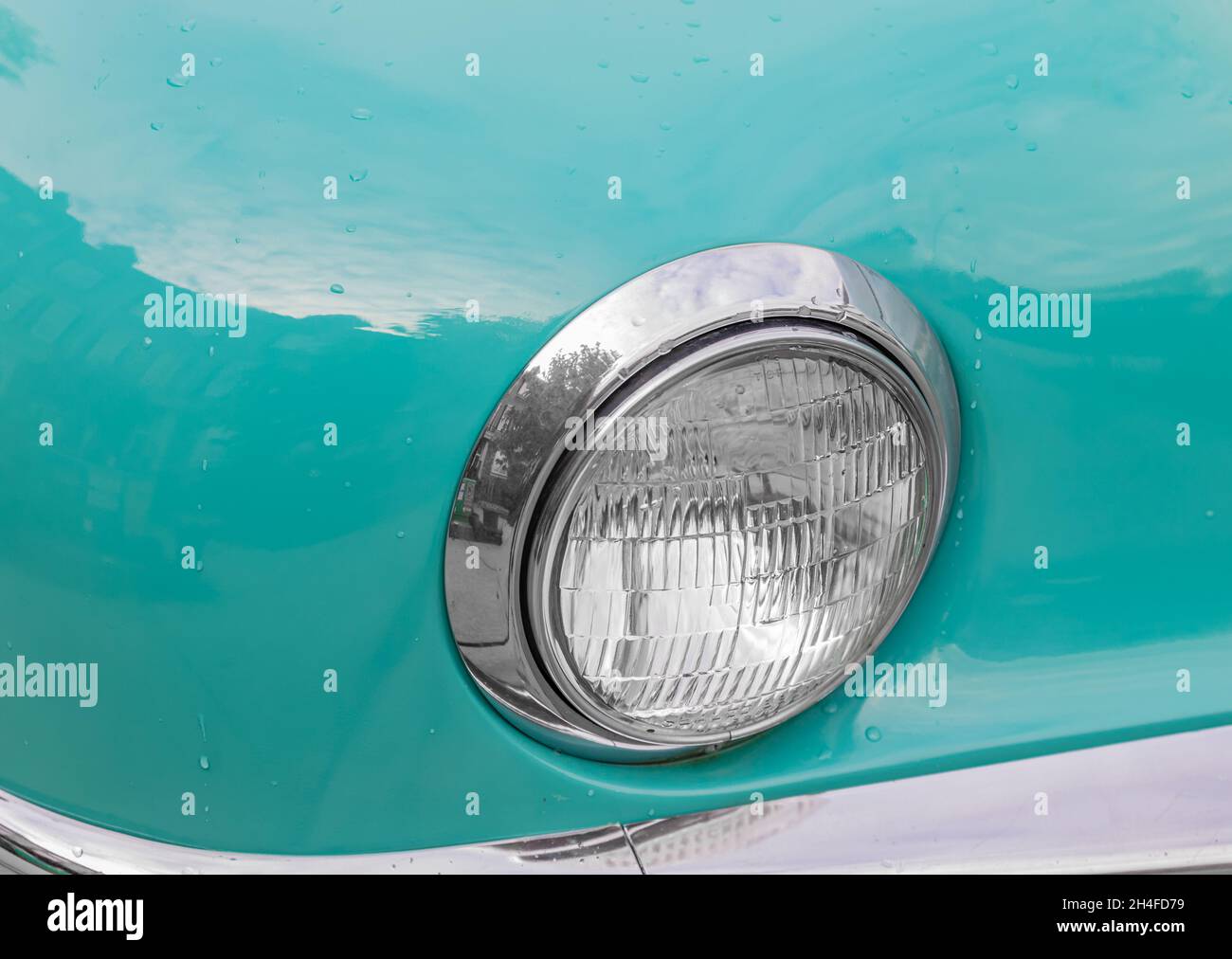 Close up headlight of colourful classic vintage car. Front and side ...