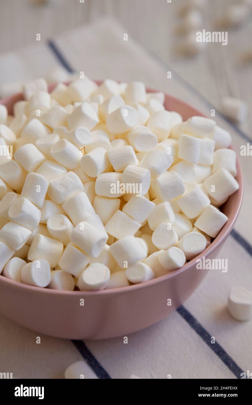 White Mini Marshmallows in a Pink Bowl, side view. Close-up Stock Photo ...