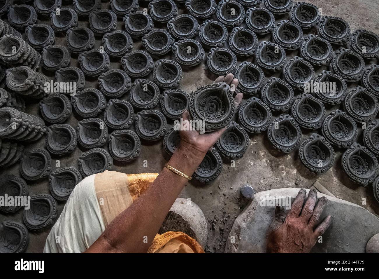 Kolkata, India. 02nd Nov, 2021. Potter is busy making Diya (lamp ...