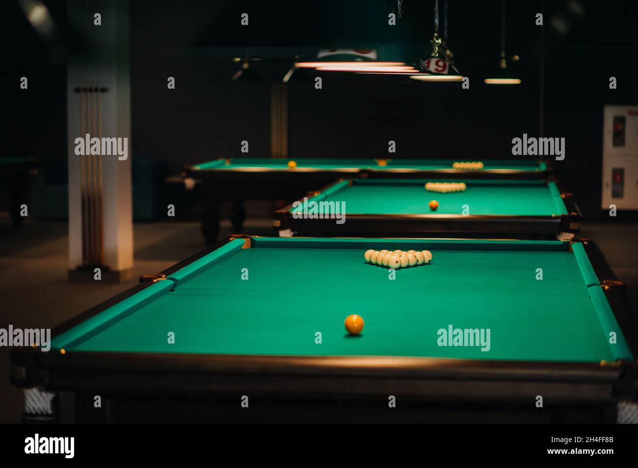 Billiard table with green surface and balls in the billiard club Stock ...