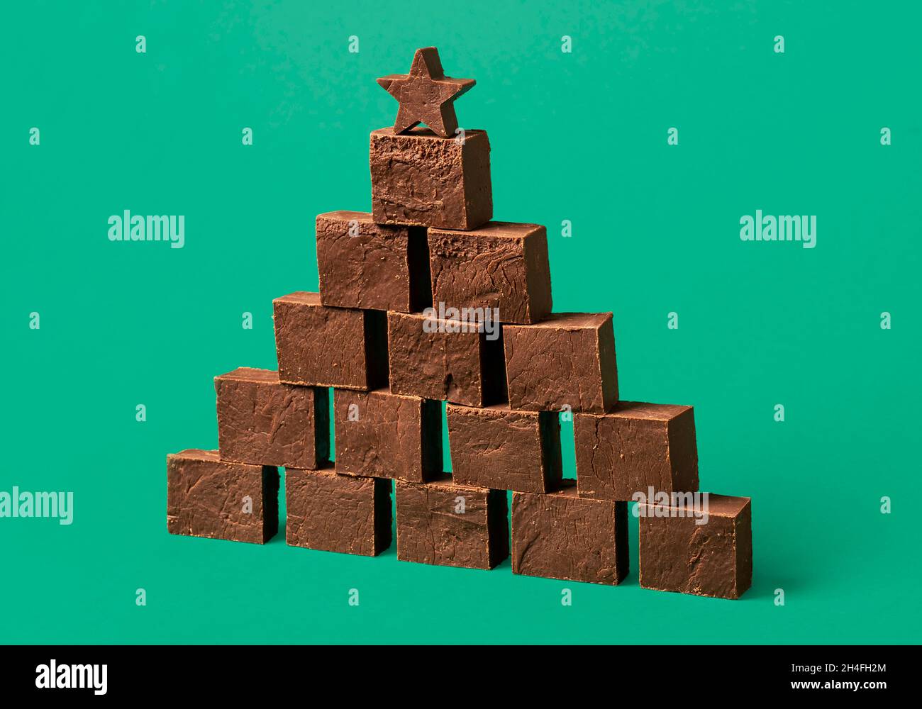 Chocolate fudge bars pile on a green-colored background. Homemade ...