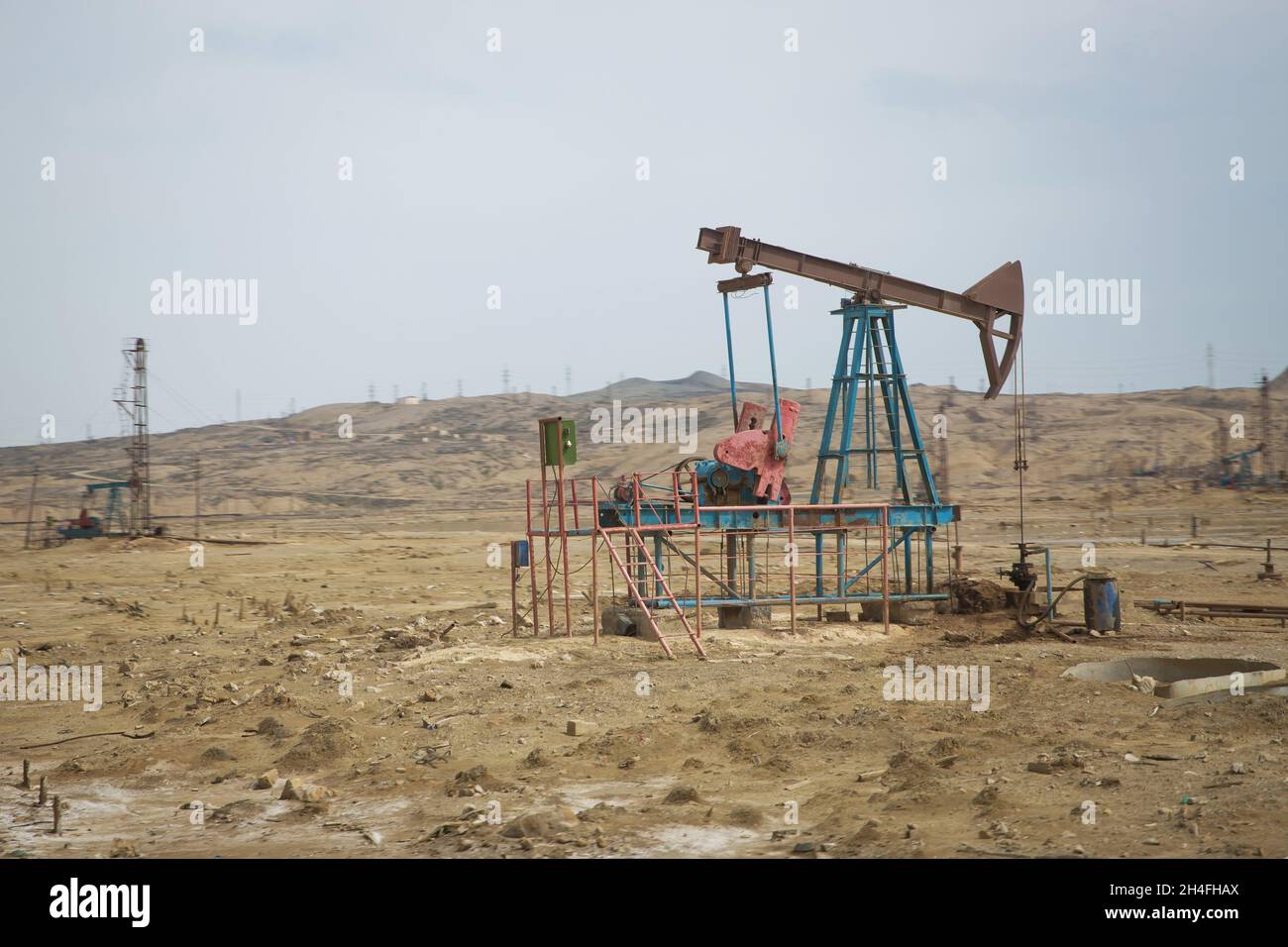 Oil and gas drilling rig onshore dessert with dramatic cloudscape ...