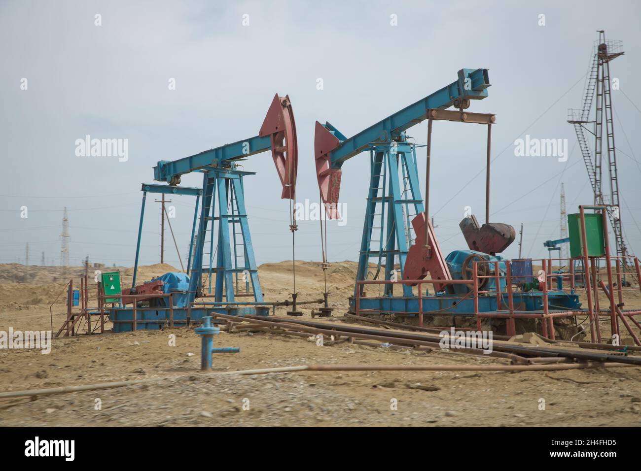 Oil and gas drilling rig onshore dessert with dramatic cloudscape ...