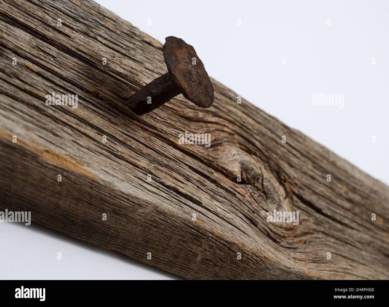 rusty forged nail hammered into an old dry board Stock Photo - Alamy