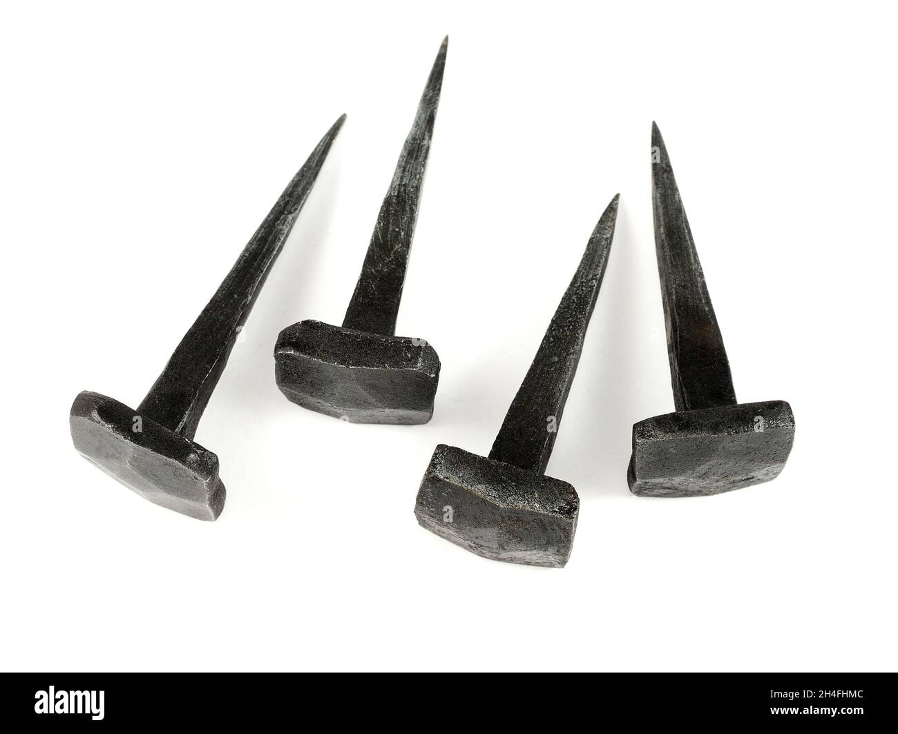 iron forged nails on a neutral background Stock Photo - Alamy
